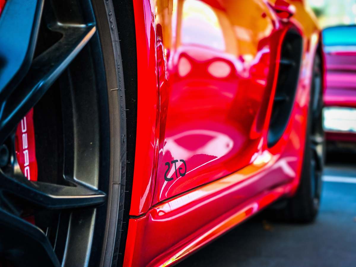 Sleek Red Car With Alloy Wheels In Urban Parking Lot Image | Free ...