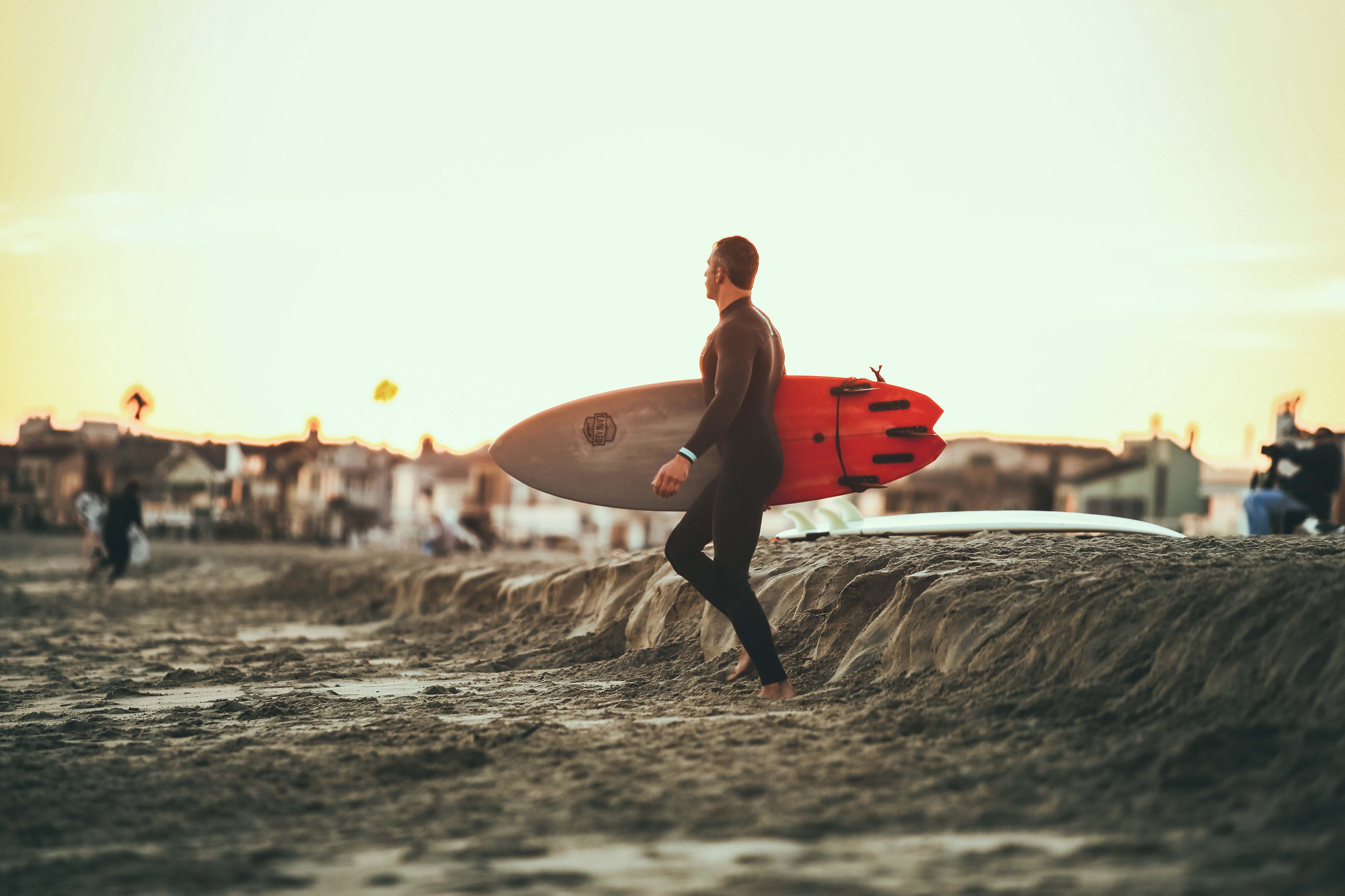 Surfer Man Struggling Through Mud With Surfboard In Daylight Image ...
